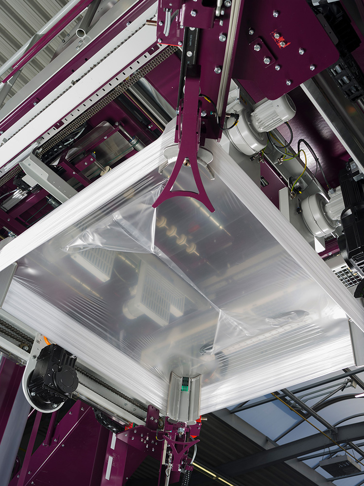 Stretch hood machine: Comprehensive load securing